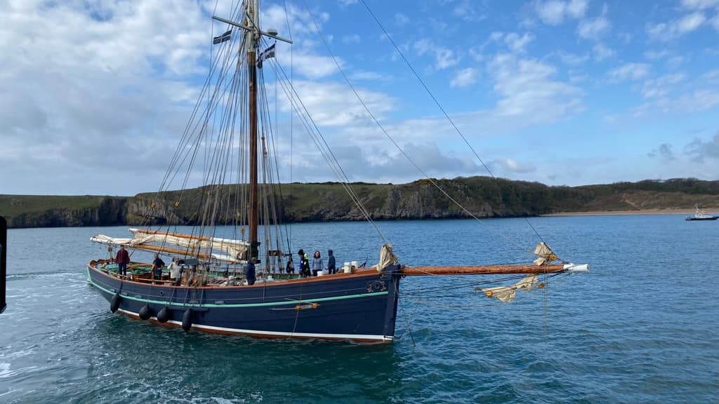 Tenby lifeboat crew launch into action to tend to injured crew member ...